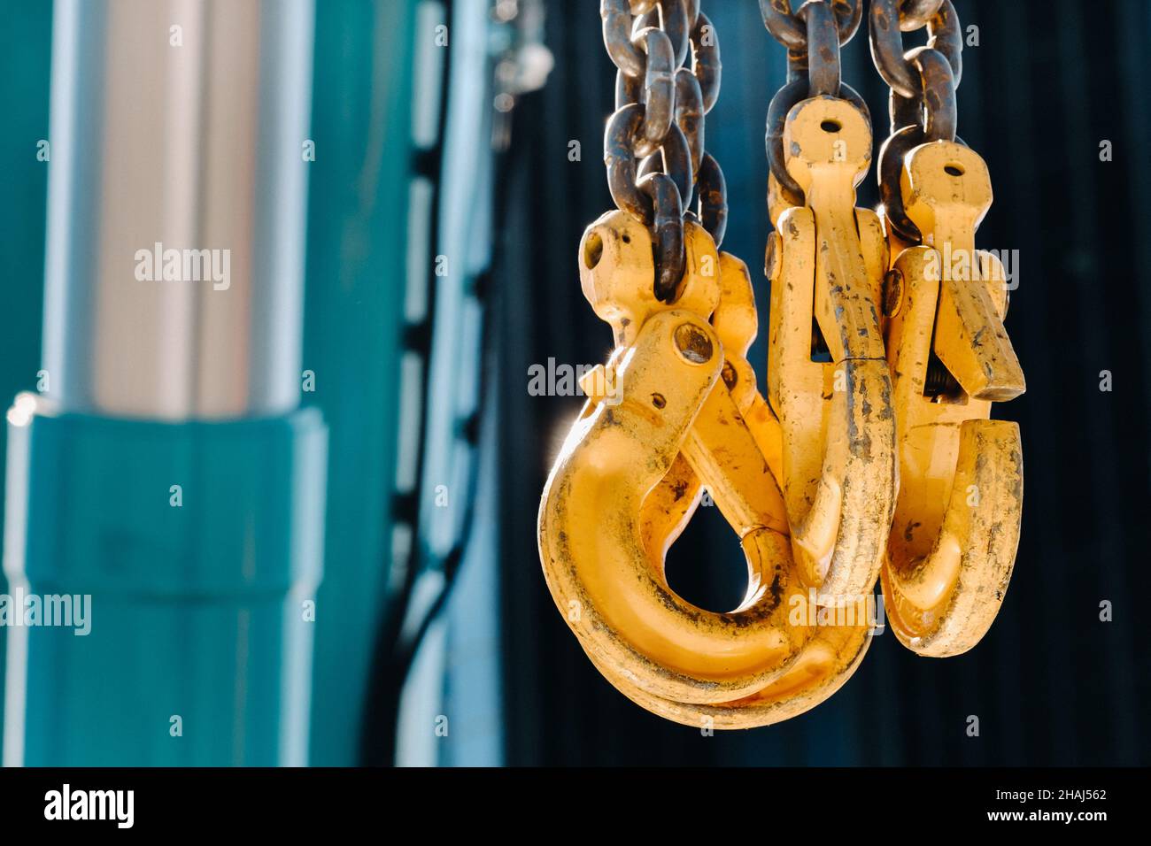 Yellow crane hooks hanging on a chain. Construction concept Stock Photo ...