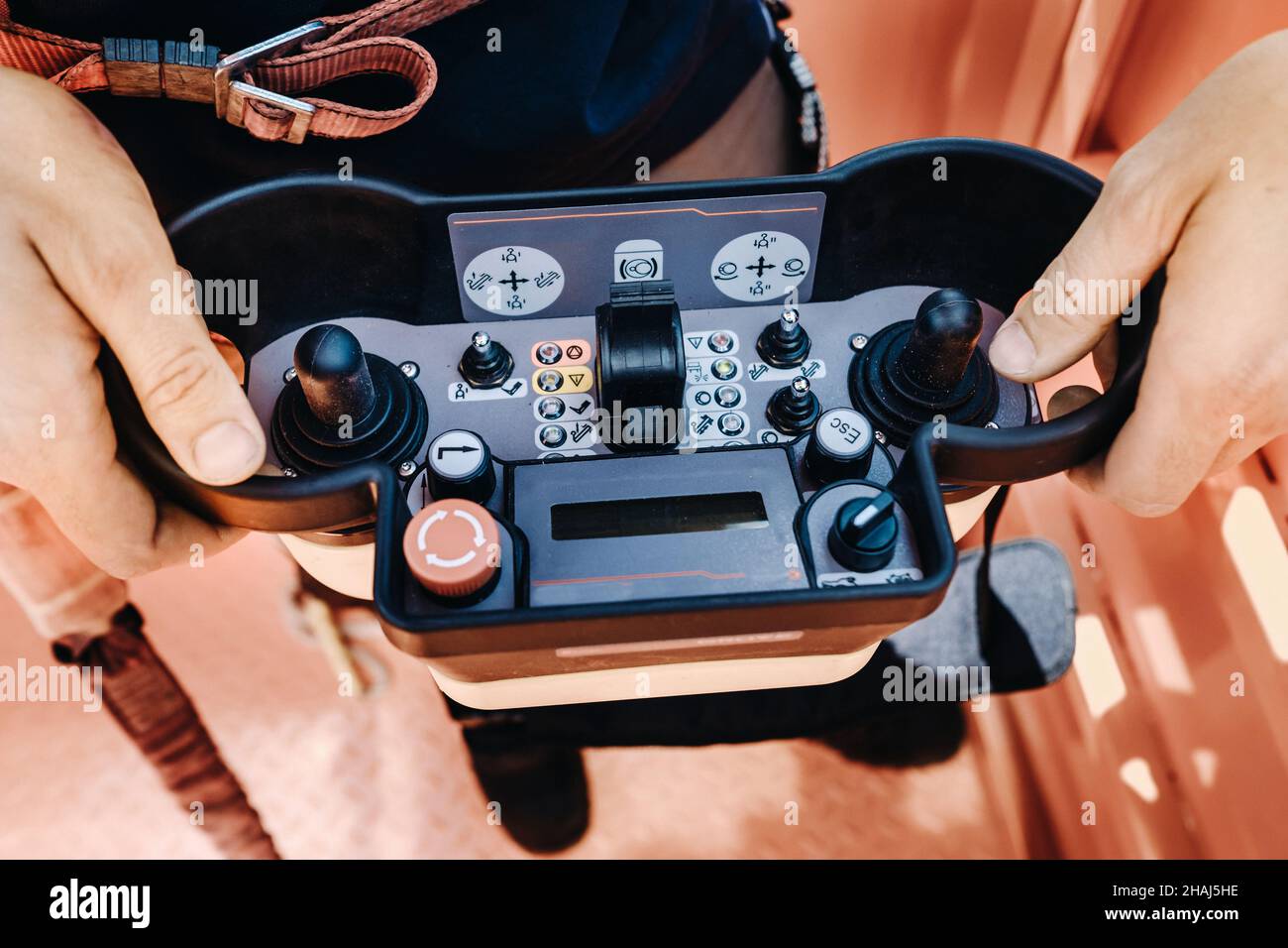 Remote control of a lifting car crane in the hands of a person. A panel ...