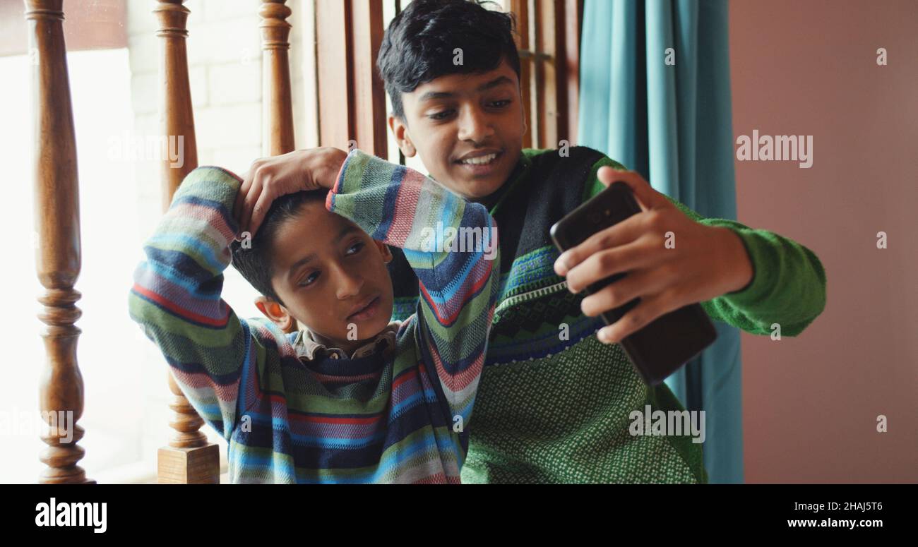 South Asian boys taking a selfie Stock Photo - Alamy