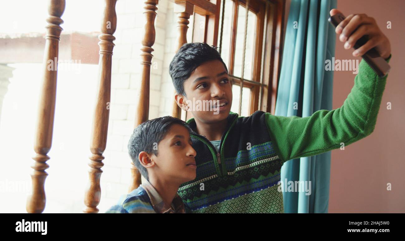 South Asian boys taking a selfie Stock Photo - Alamy