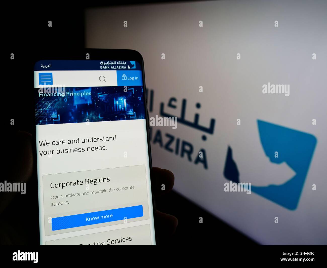 Person holding cellphone with website of Saudi Arabian company Bank ...