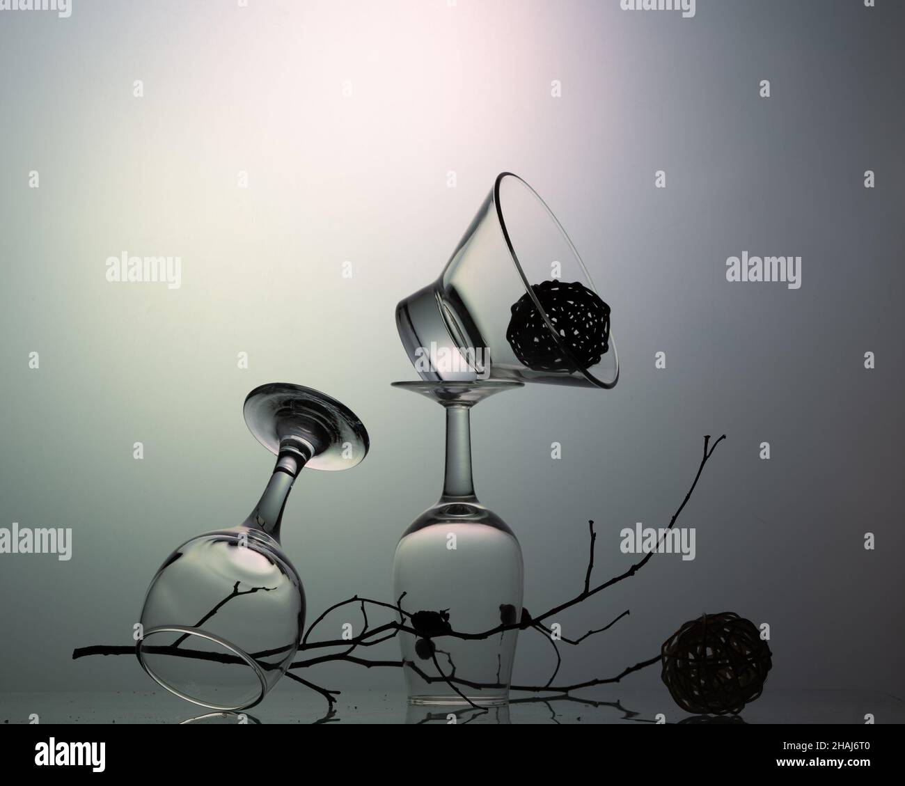 Still life with glassware and a dry tree branch Stock Photo - Alamy