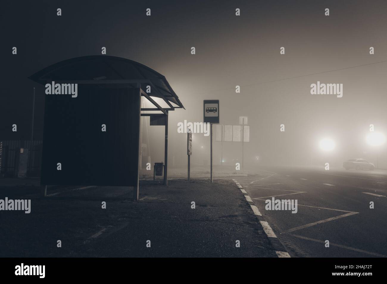 Lonely empty bus stop at foggy night Stock Photo - Alamy