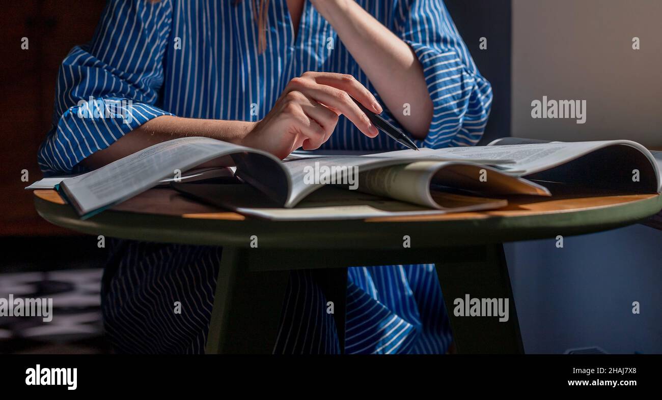 Open books, textbooks close up. Education concept. Women hand with pen ...