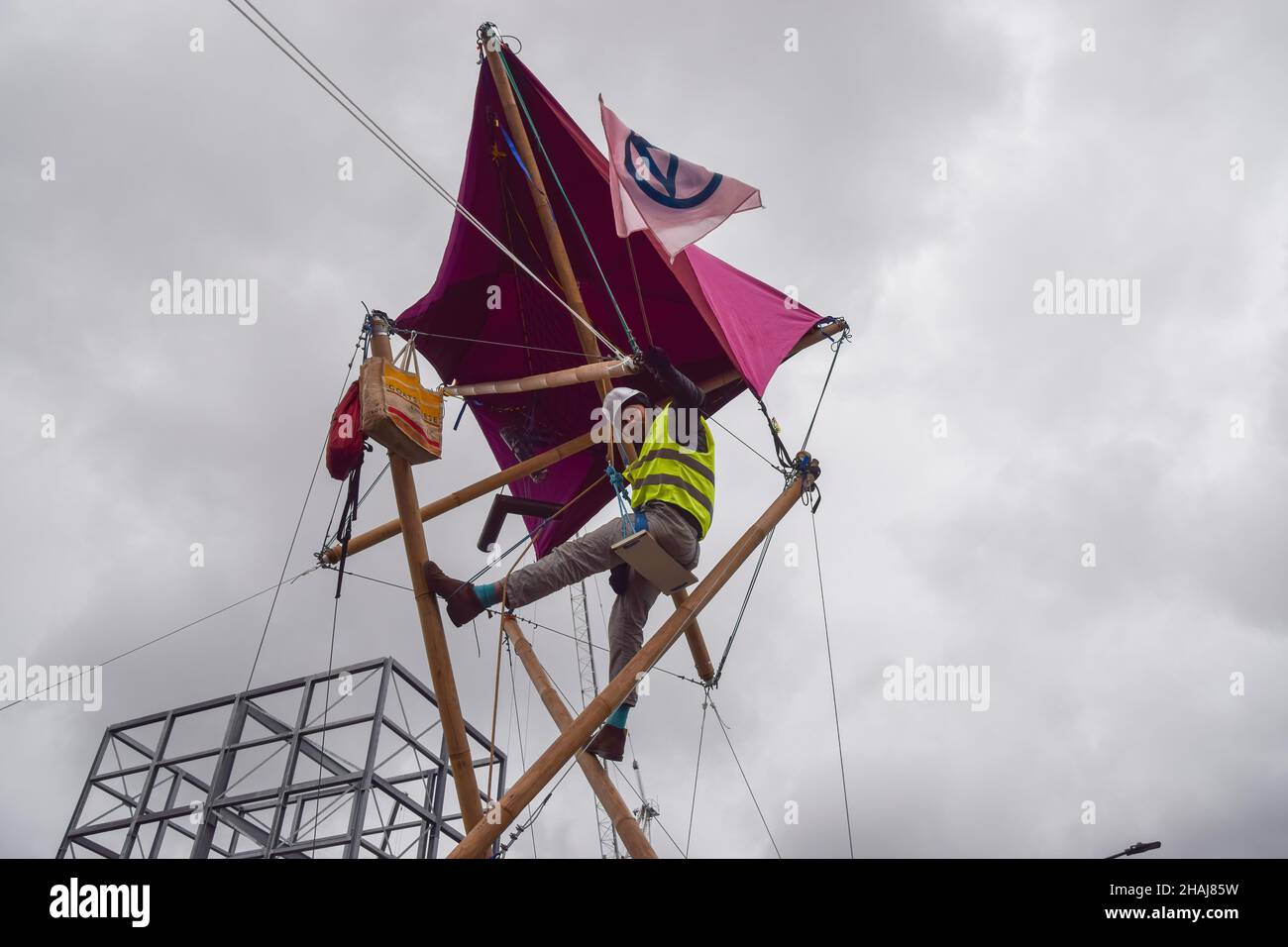 A protester sits on a bamboo structure during the demonstration ...