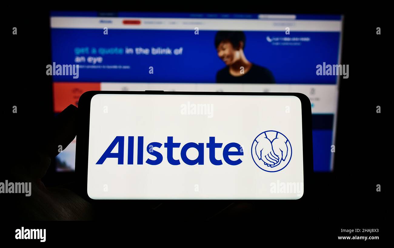 Person holding cellphone with logo of US insurance company The Allstate ...