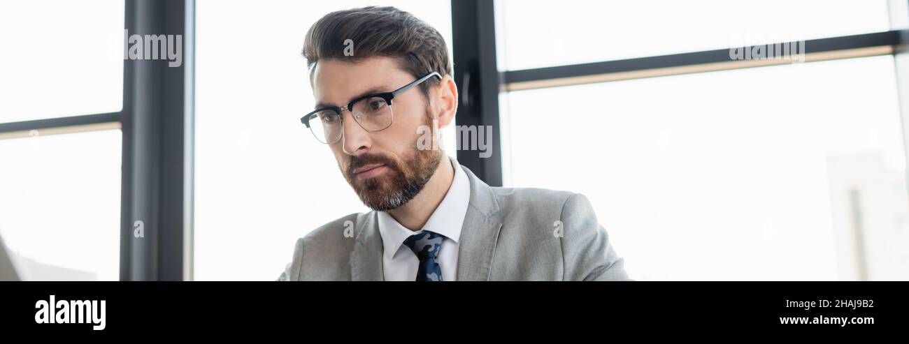 Bearded manager in suit working in office, banner Stock Photo - Alamy