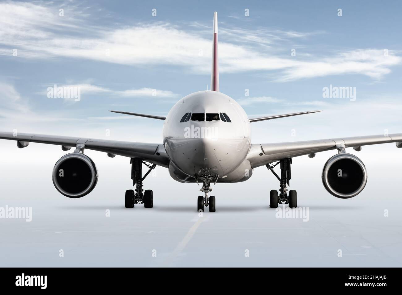 Front view of wide body passenger airplane isolated on bright ...