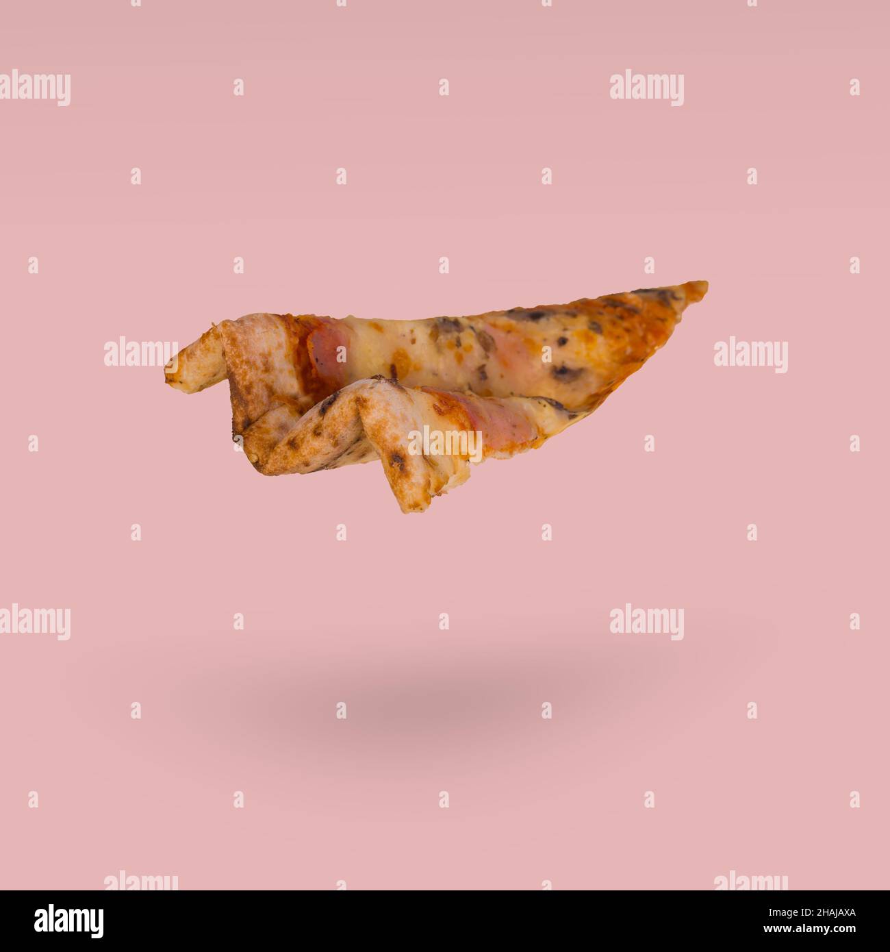 Pizza slice flying in air isolated on a pastel pink background ...