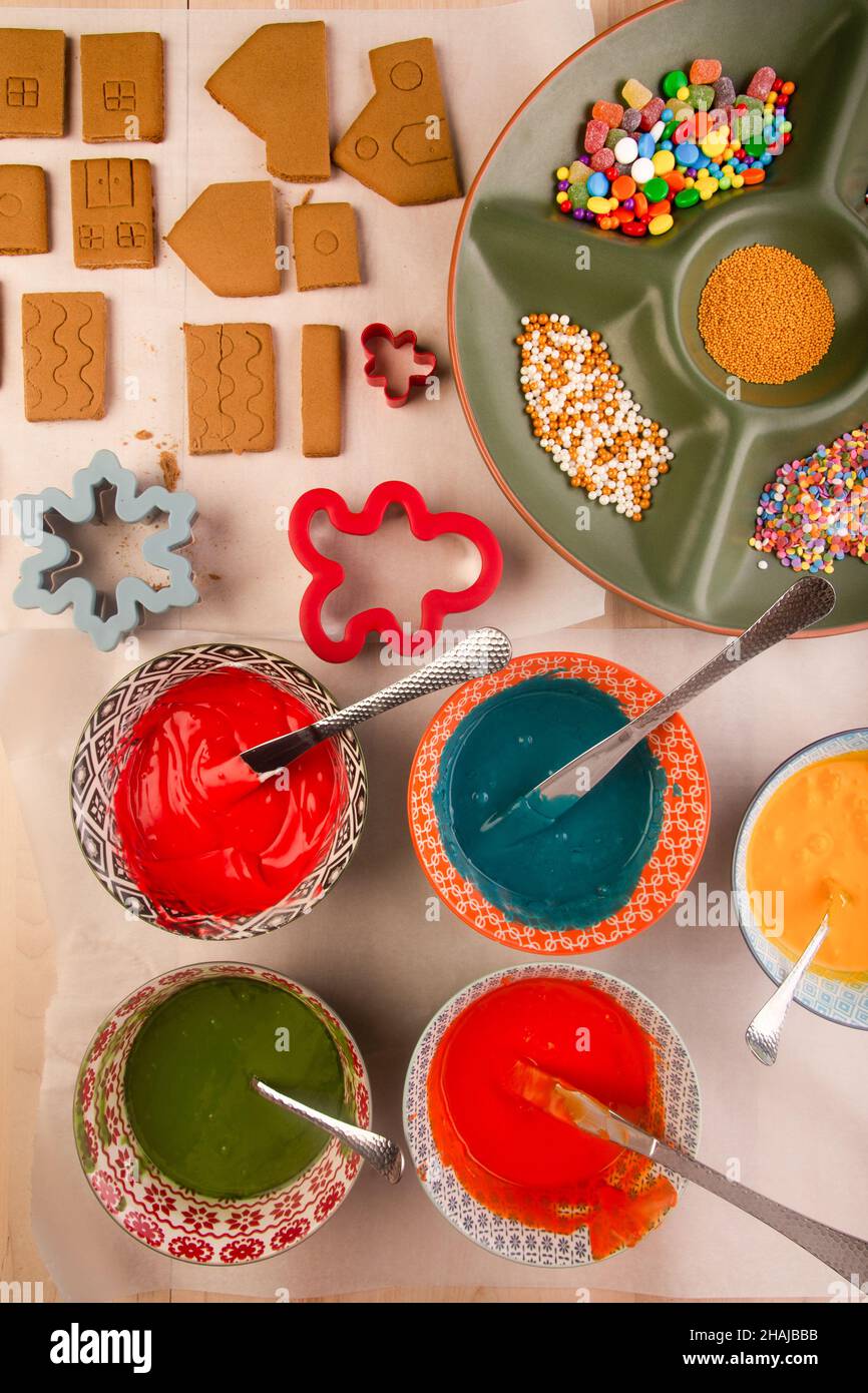 Gingerbread house cookies ready to be decorated with coloured royal ...
