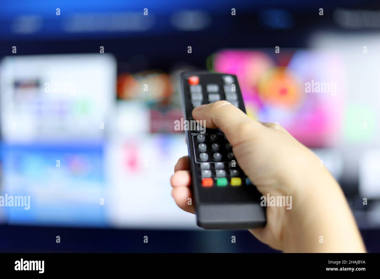 Female hand with remote controller on smart TV screen background. Woman ...