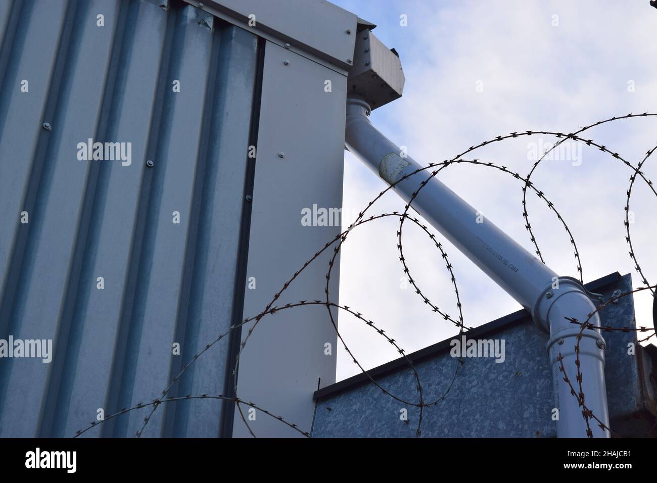 Barbed wire wall and fence Stock Photo - Alamy