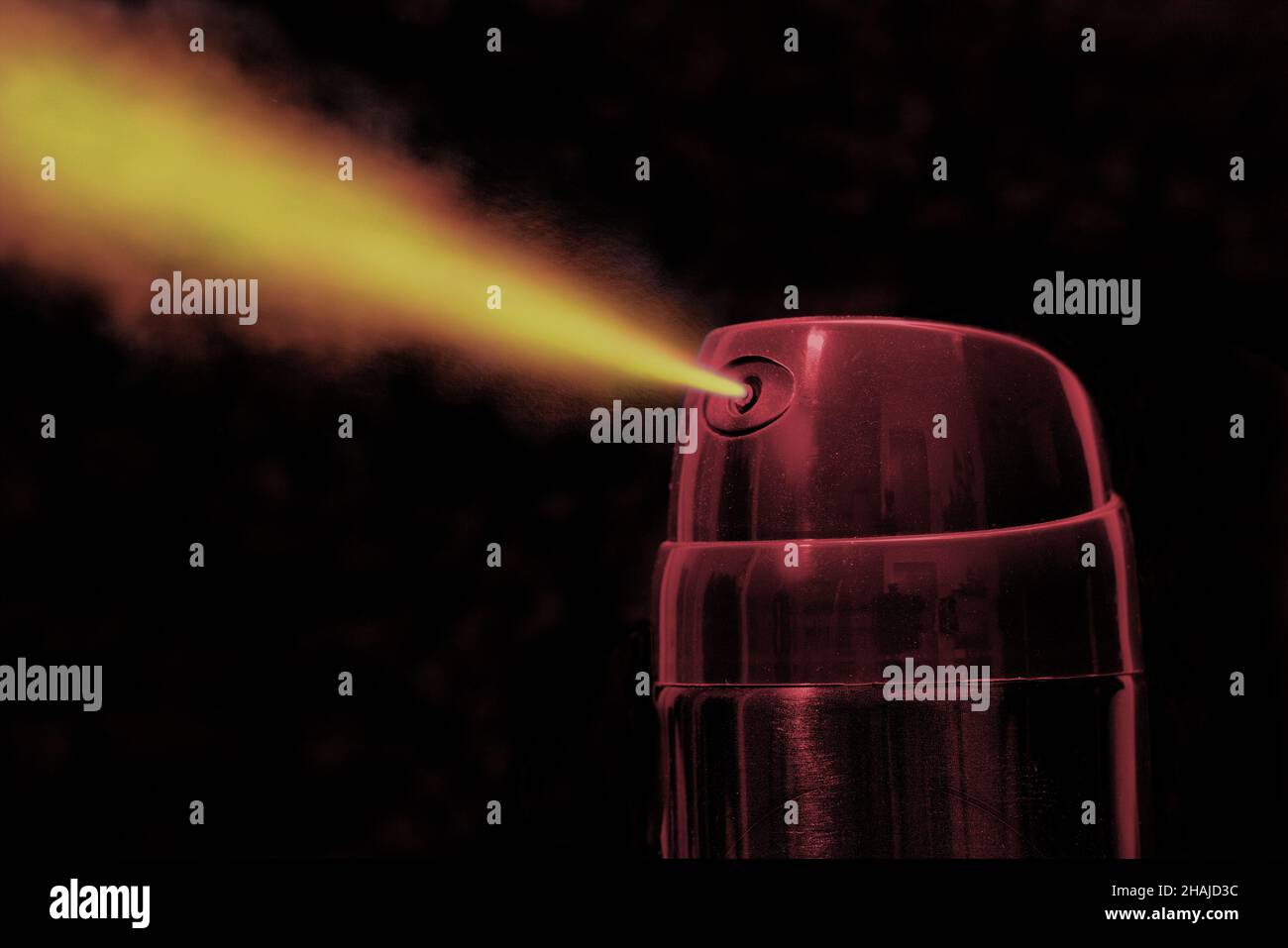 Aerosol deodorant can firing hot colored spray Stock Photo - Alamy