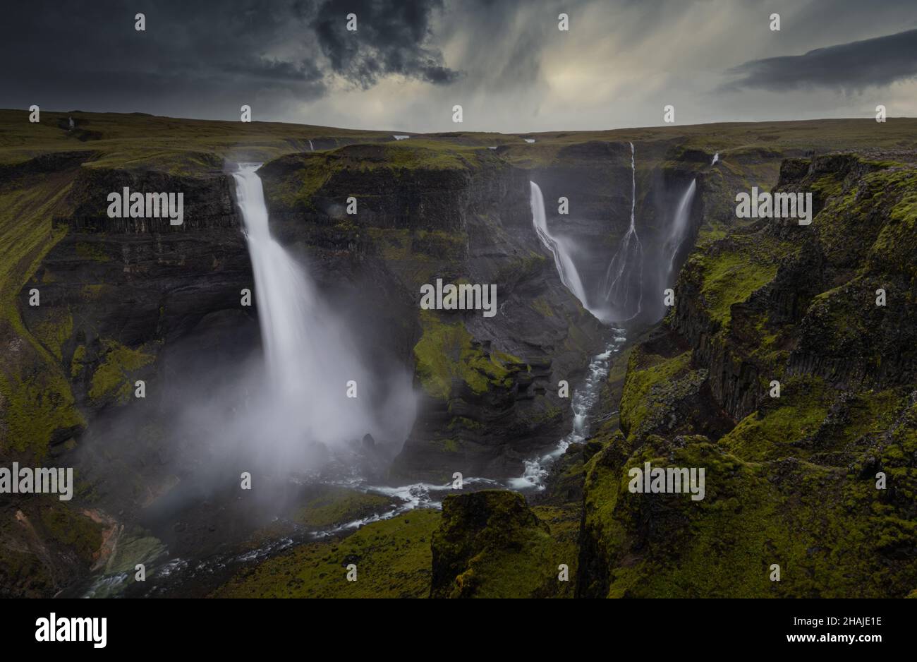Breathtaking shot of high waterfalls in beautiful cliffs, with a black ...
