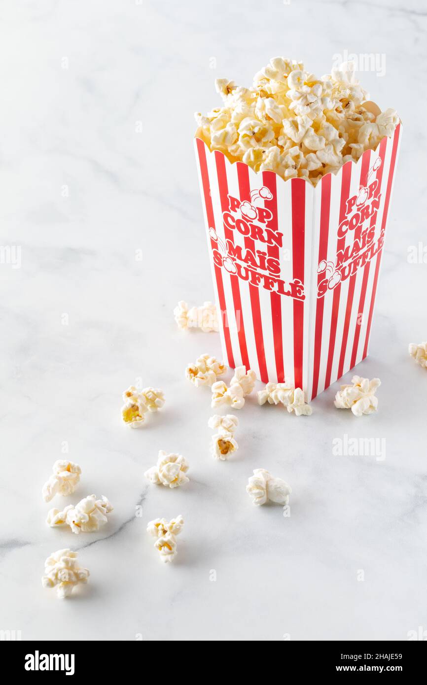 A cardboard carton filled with popcorn, ready for snacking Stock Photo ...
