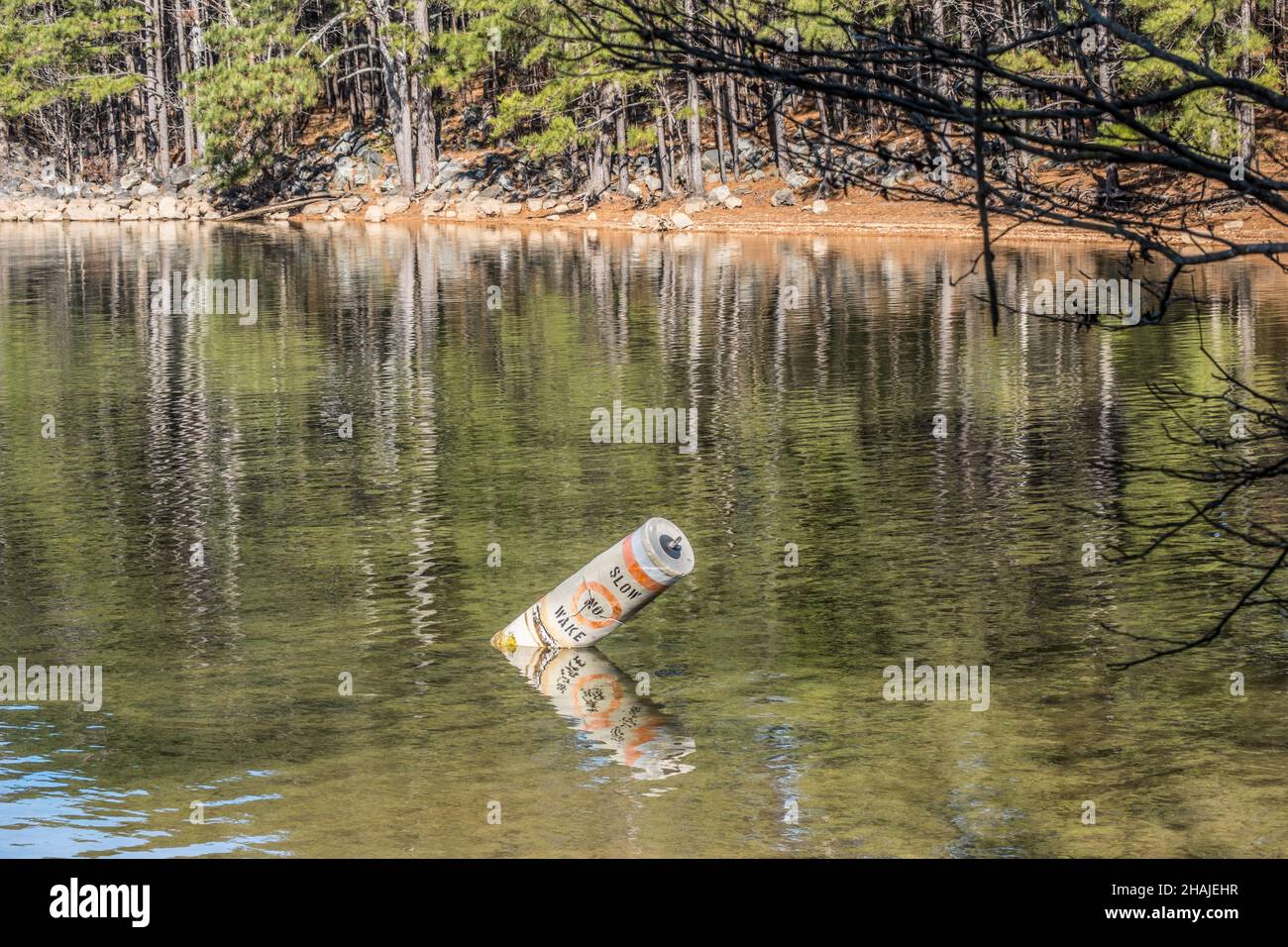 Broken and cracked no wake buoy floating on its side a warning to go ...