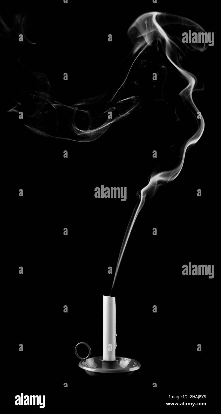 One candle with flame extinguished, smoke, on black background Stock ...