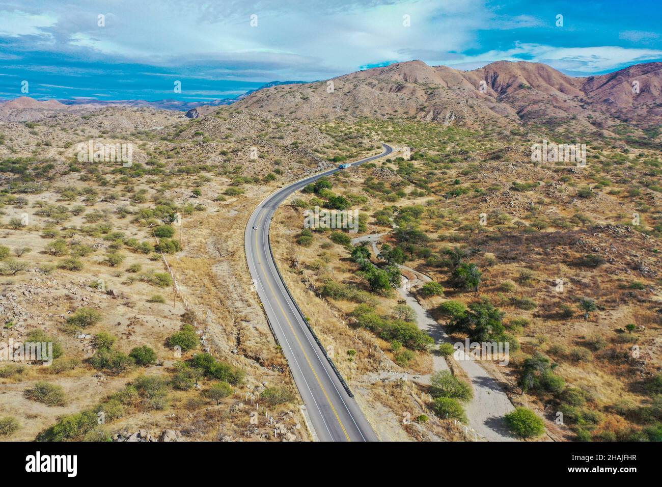 Aerial view of the landscape of the mountains and the road that goes ...