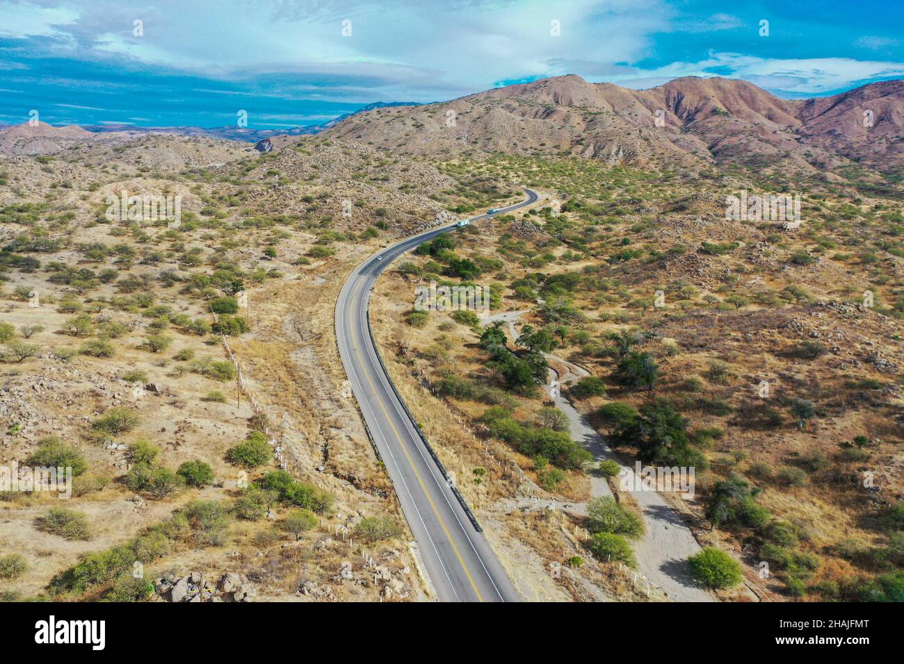 Aerial view of the landscape of the mountains and the road that goes ...