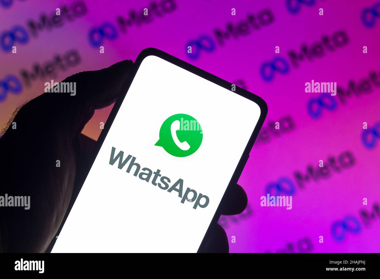 In this photo illustration a WhatsApp logo seen displayed on a smartphone with a Meta Platforms ...