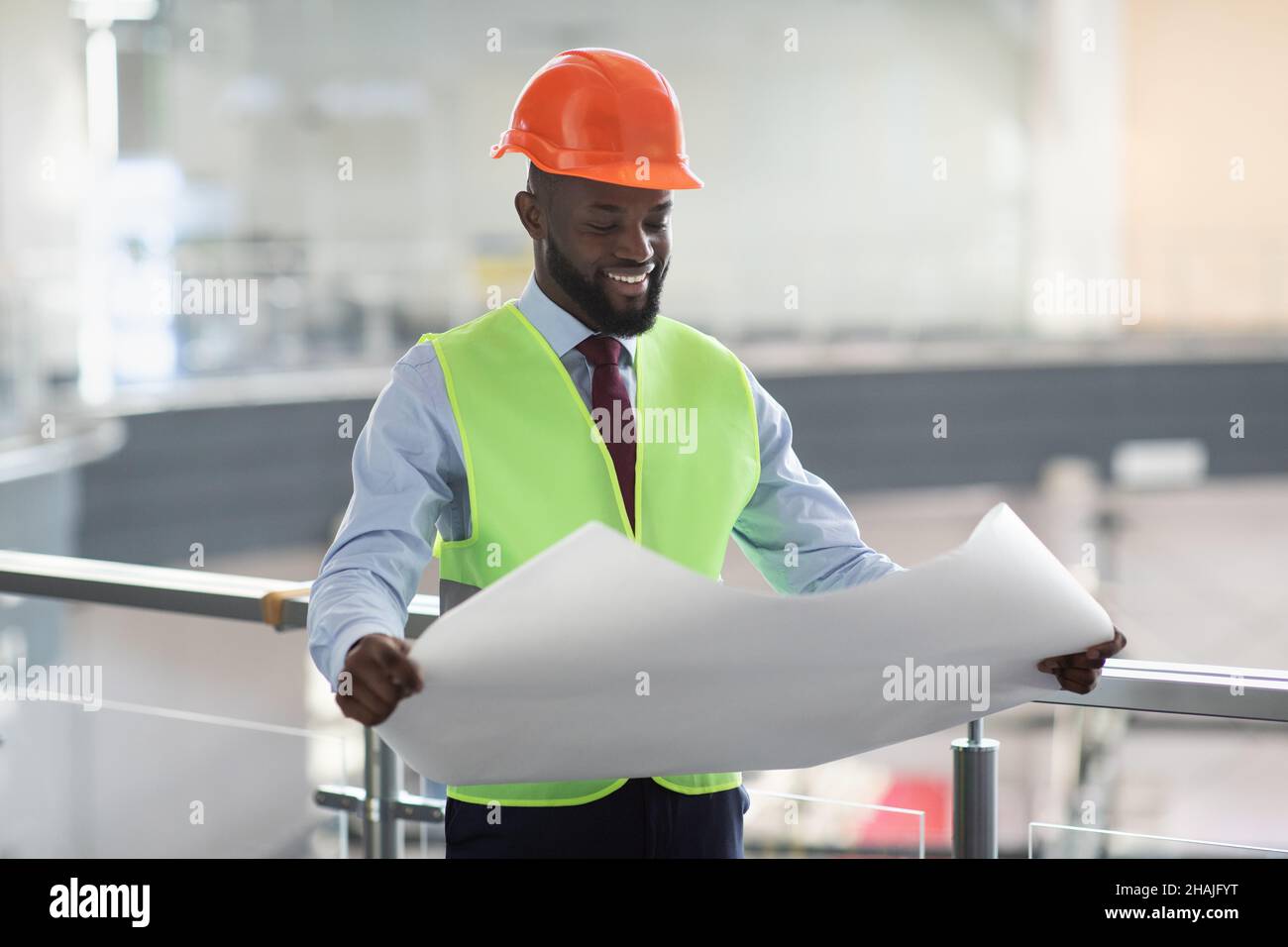 African american guy engineer holding paper drawing template Stock ...