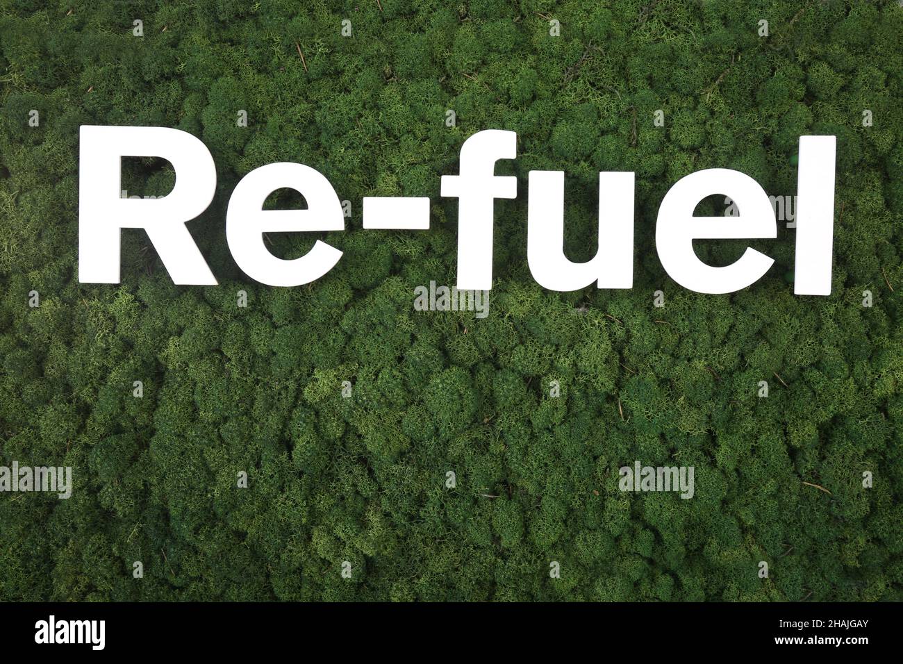 White letters on green background spelling Re-Fuel. Letter at top of ...