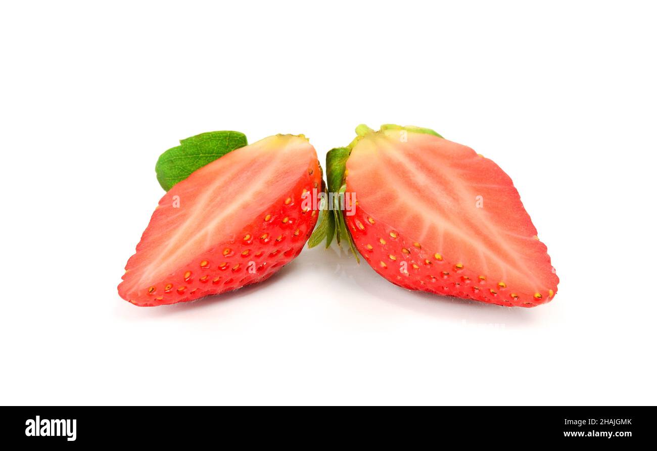 Fresh strawberries cut in half on a white background Stock Photo - Alamy