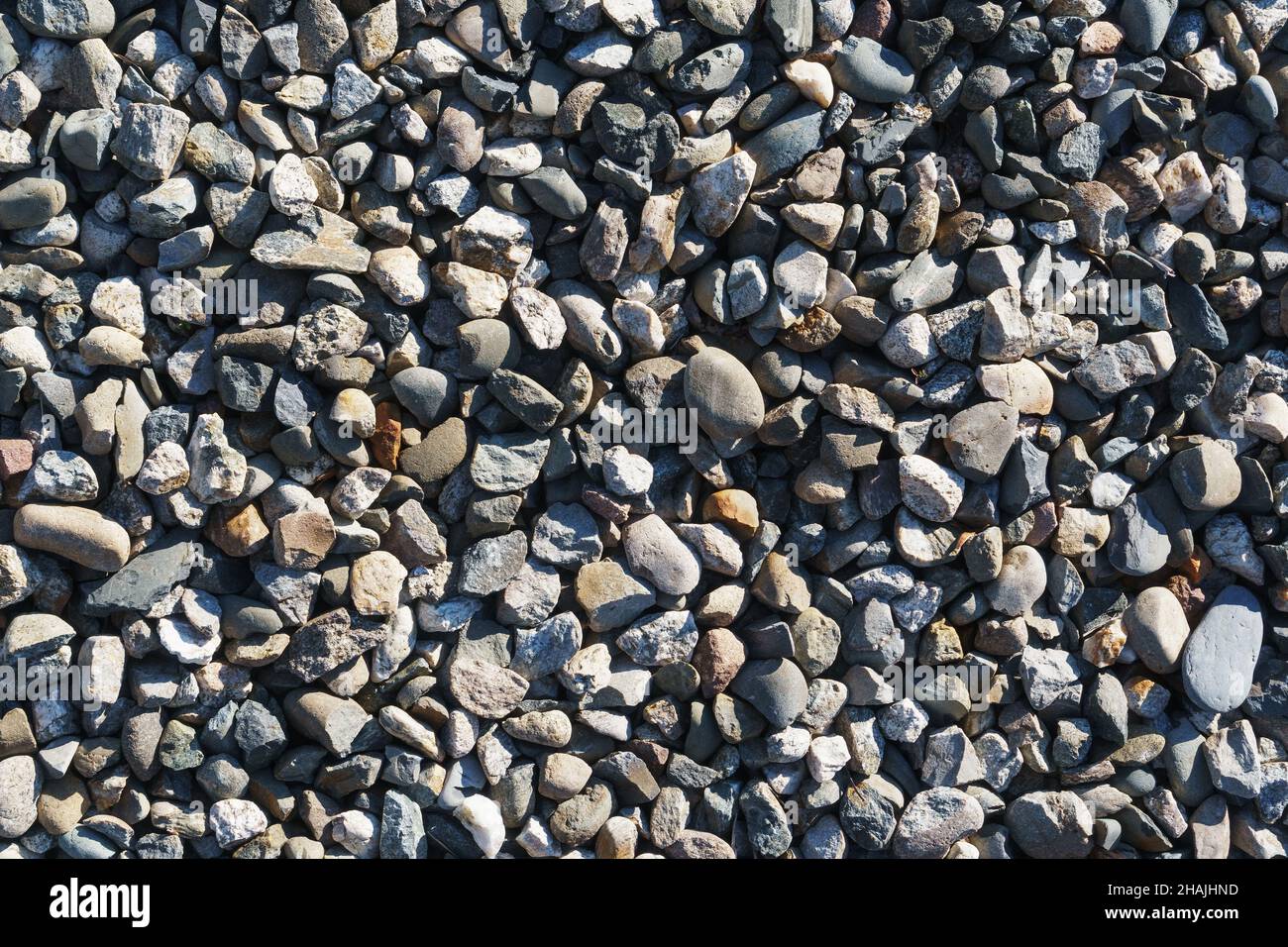 The texture of coarse gravel in full screen as a background. View from ...