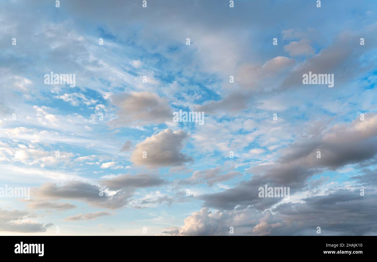 Evening sky with some yellow, white, grey and dark clouds Stock Photo ...