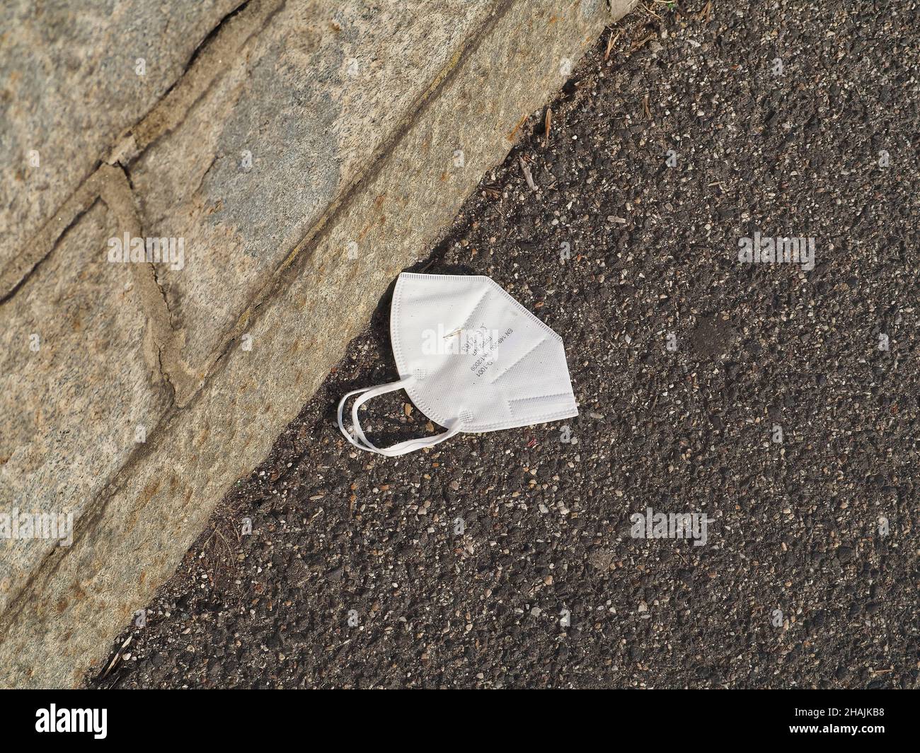 Top view of a white face mask on the ground Stock Photo - Alamy
