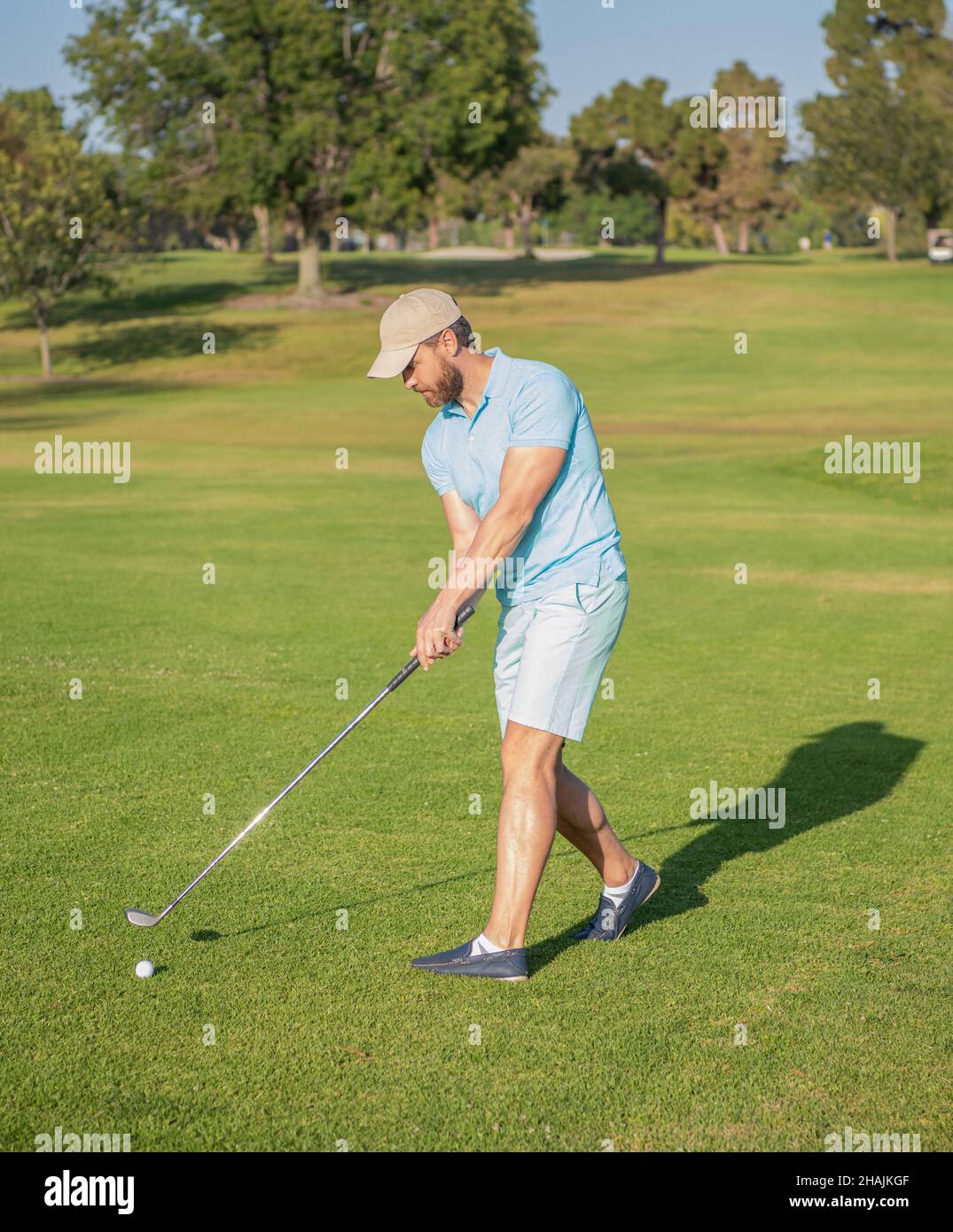male golf player on professional golf course. portrait of golfer in cap ...