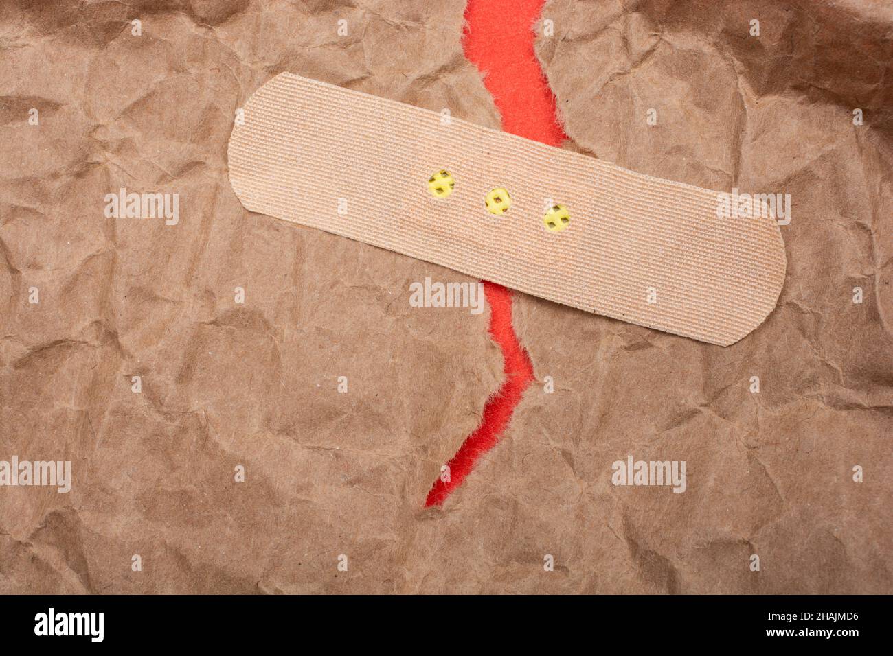 Plastering band on torn paper Stock Photo - Alamy