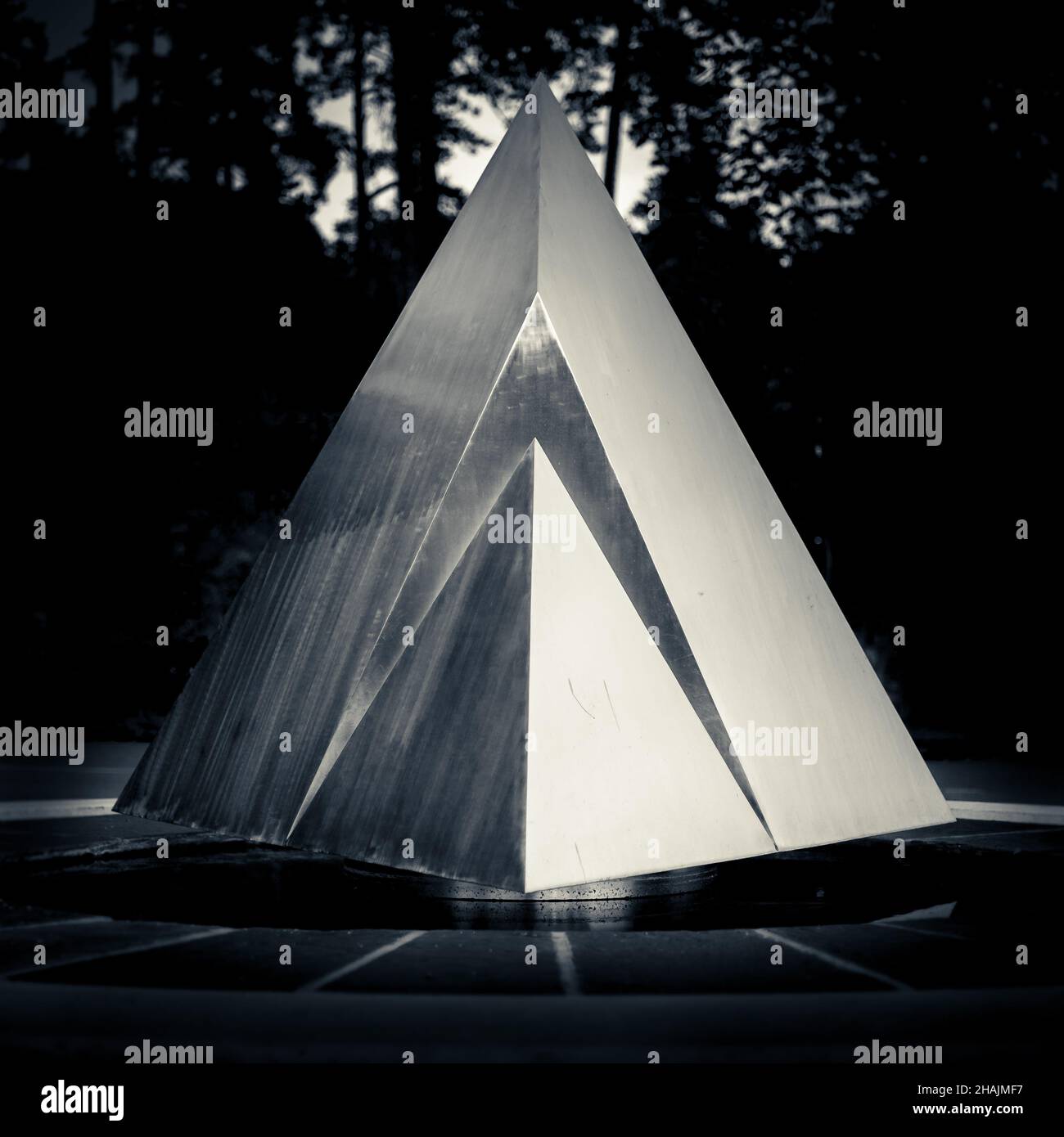 Modern pyramid shape metal building on a grayscale Stock Photo - Alamy