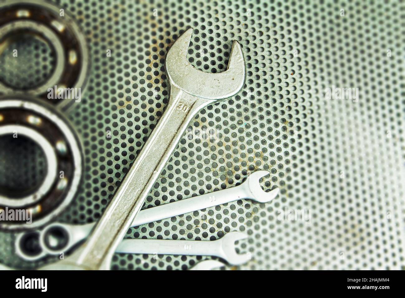 Metalworking tools, steel parts, a wrench, on the background of a metal ...