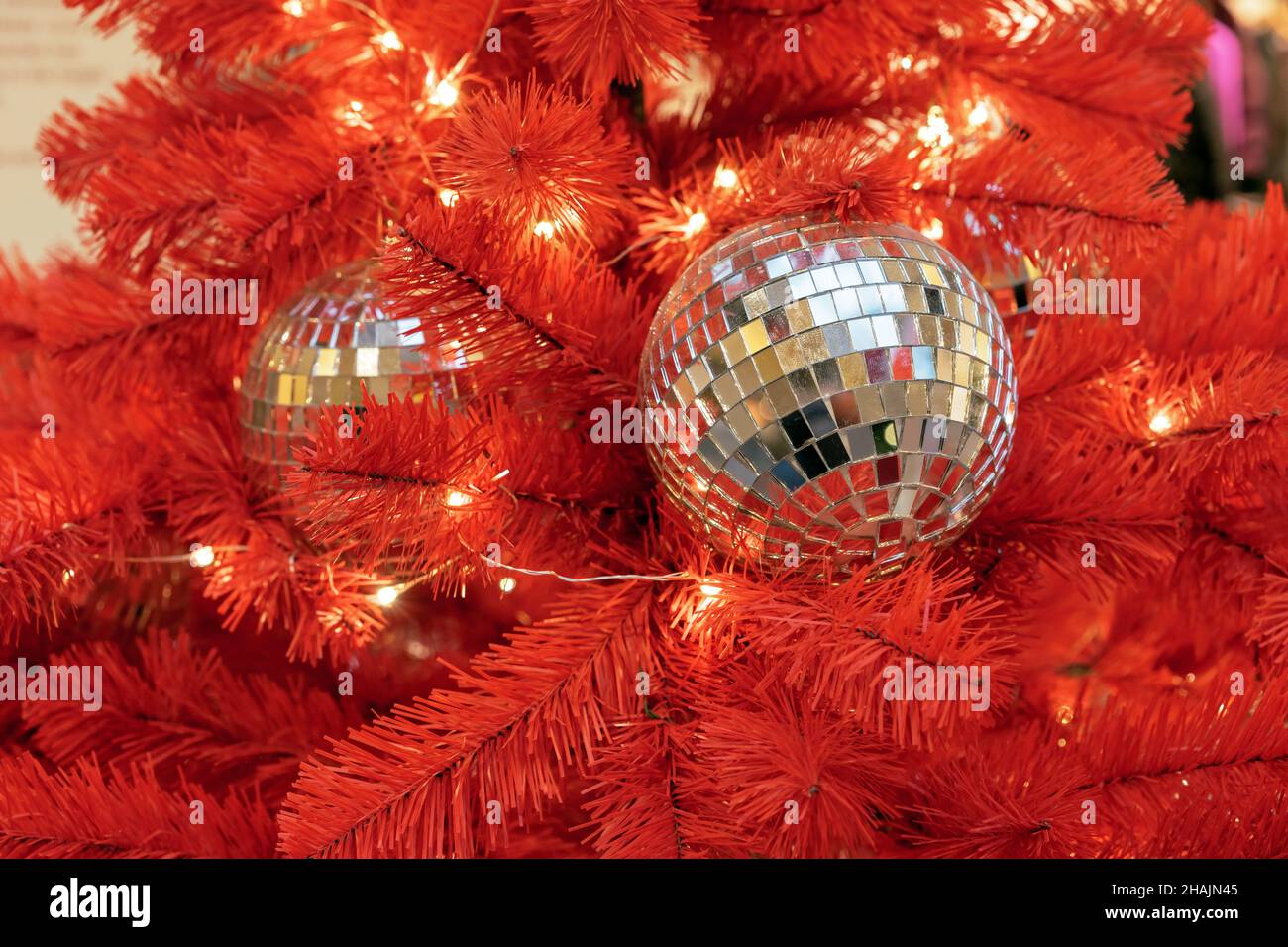 Christmas disco balls on a red Christmas tree Stock Photo - Alamy