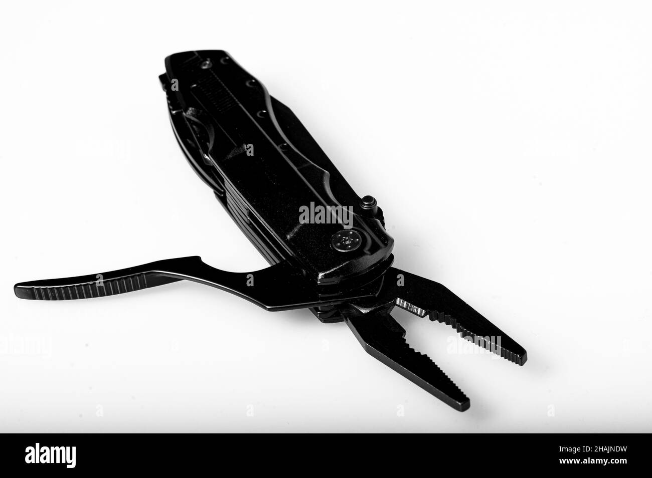 Closeup of the black multi-tool on white background Stock Photo - Alamy