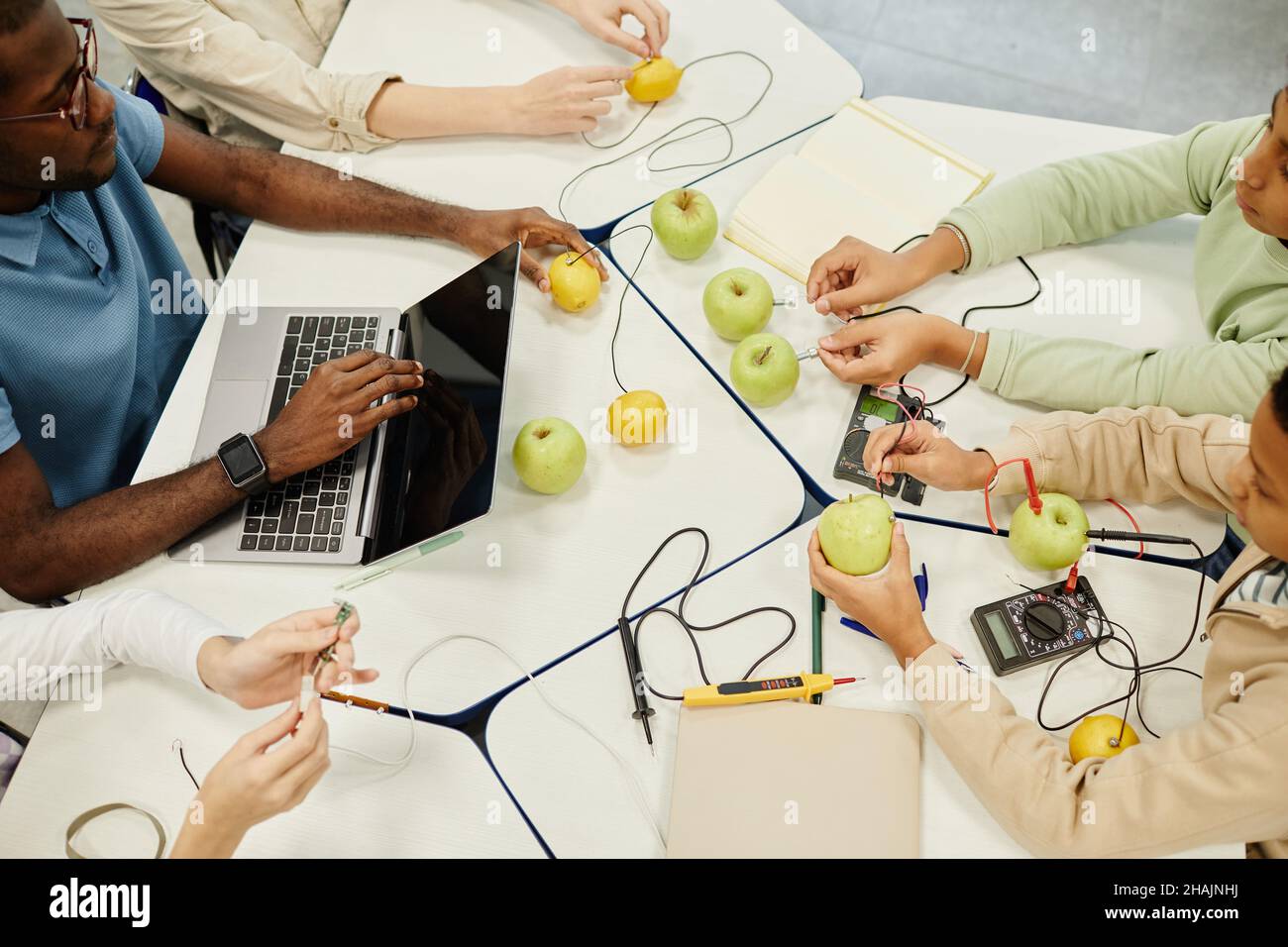 Top view of diverse group of children making science experiments with ...