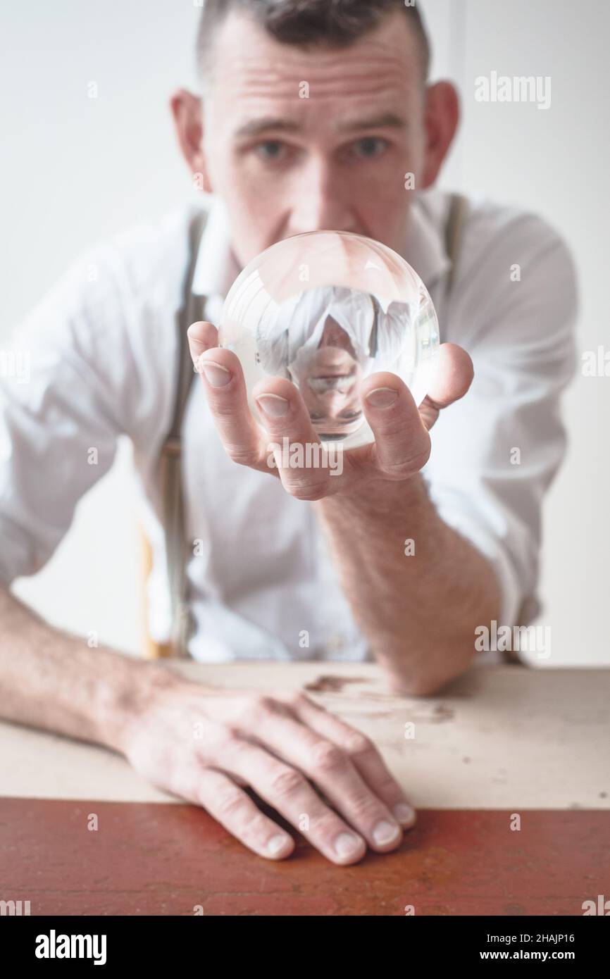 handsome man in his 50s looks at a crystal ball Stock Photo - Alamy