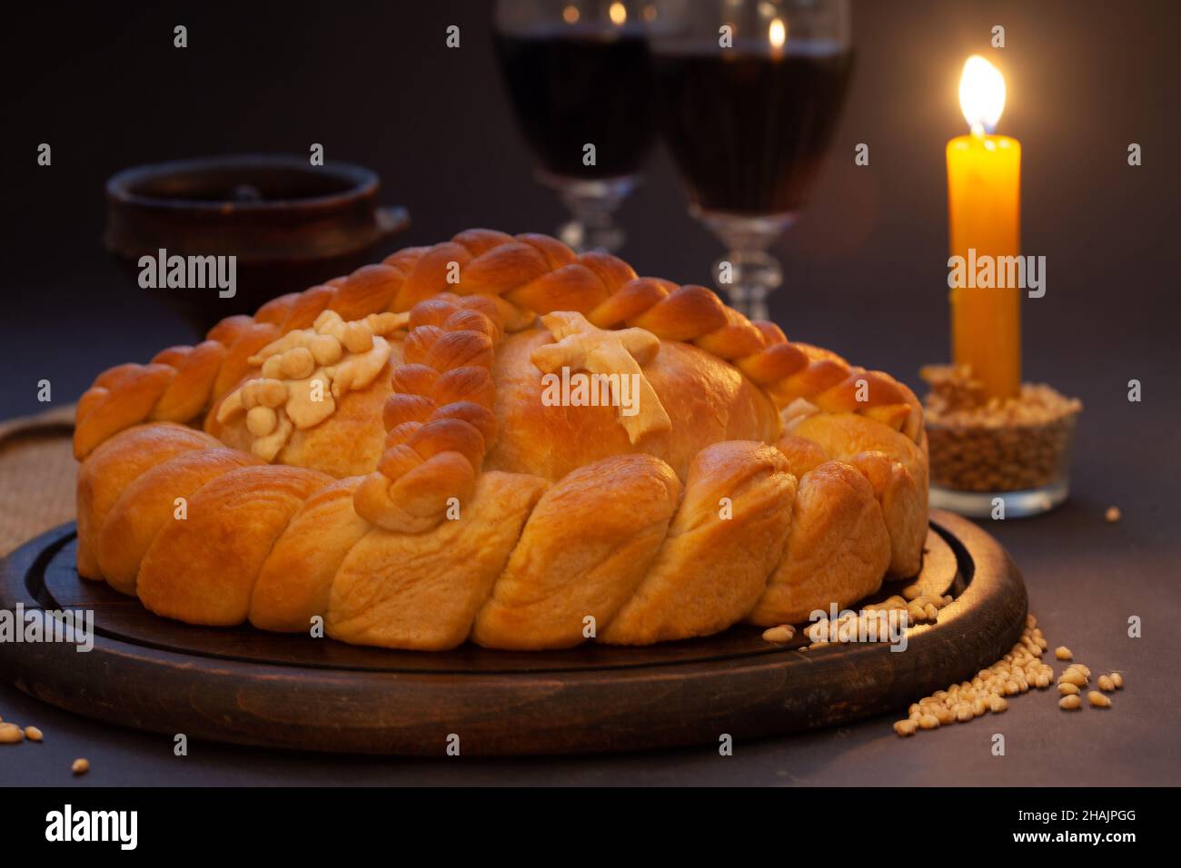 Serbian slava cake with wine and candle. Slavski kolač. Decorative ...