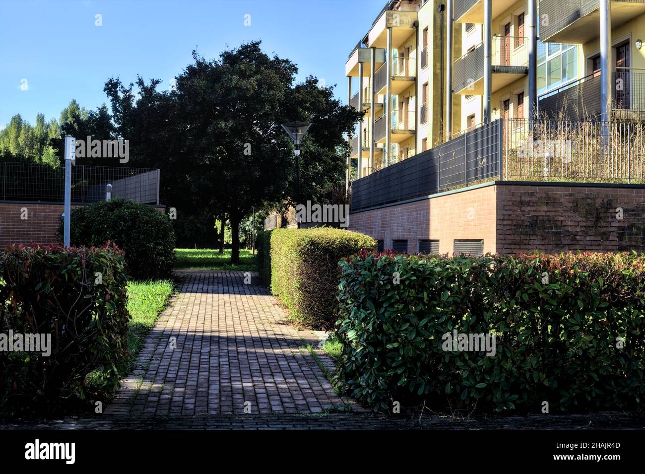 Passageway with trees between buildings in the countryside Stock Photo ...