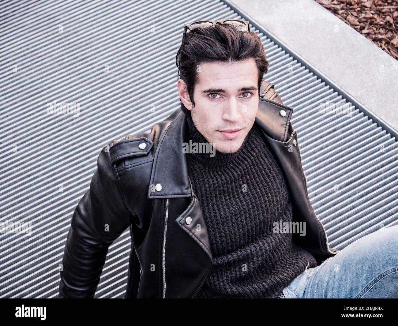 Young man on metal grid looking at camera Stock Photo - Alamy