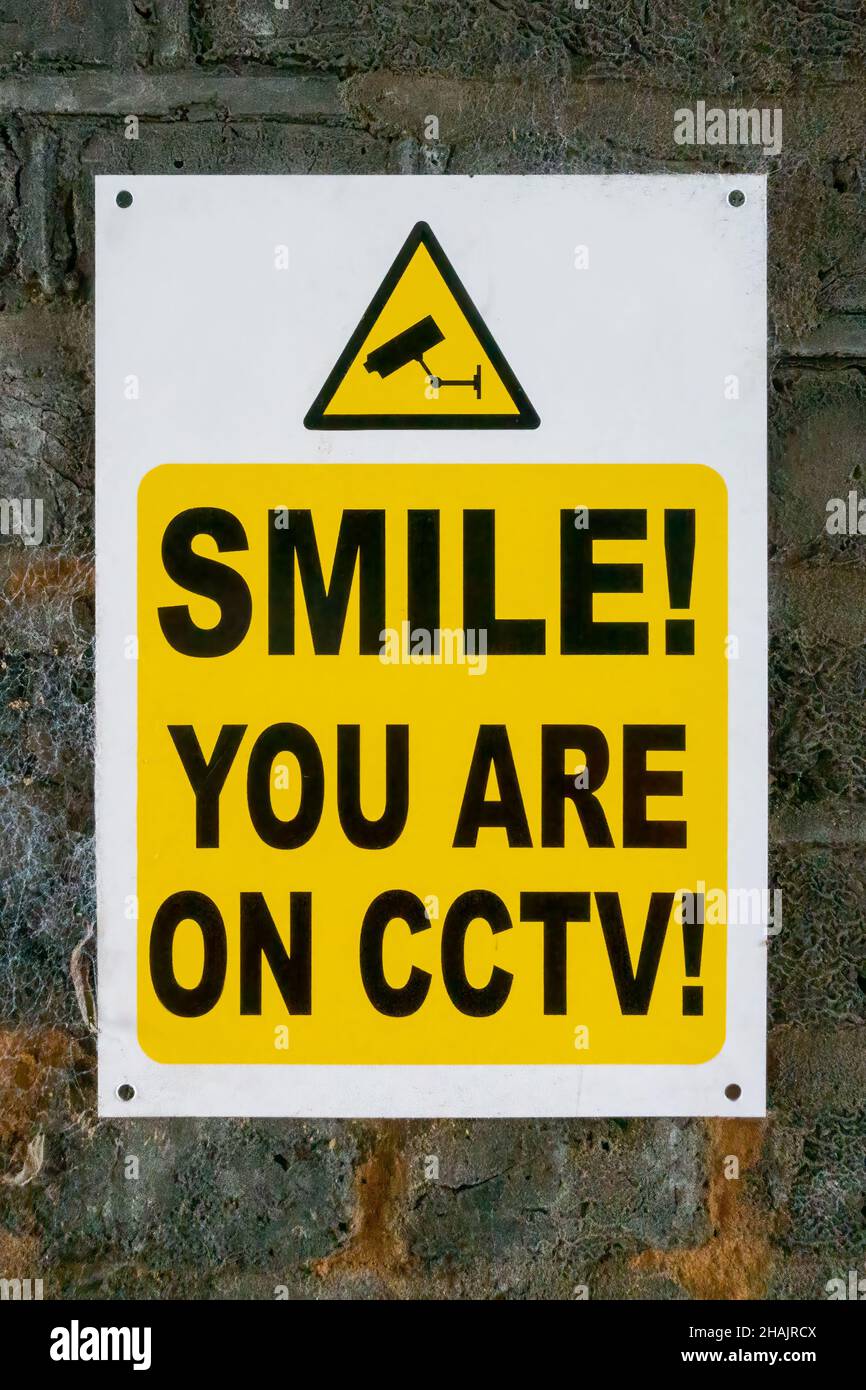 Smile you are on CCTV sign on a brick wall Stock Photo - Alamy