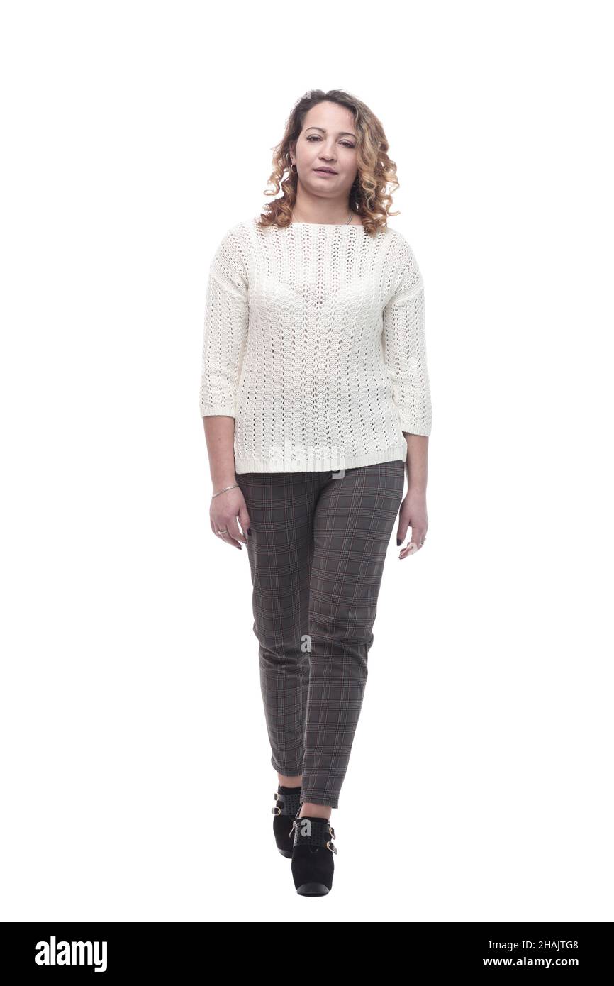 attractive young woman in a white jumper striding forward Stock Photo ...