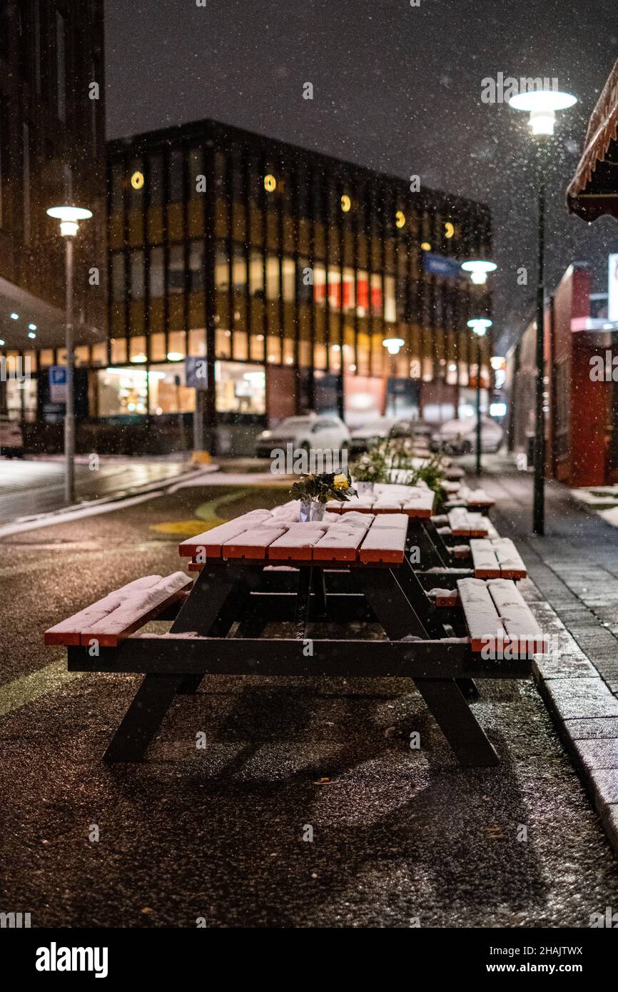 Reykjavik Iceland street scene rainbow night time lighting snow falling ...