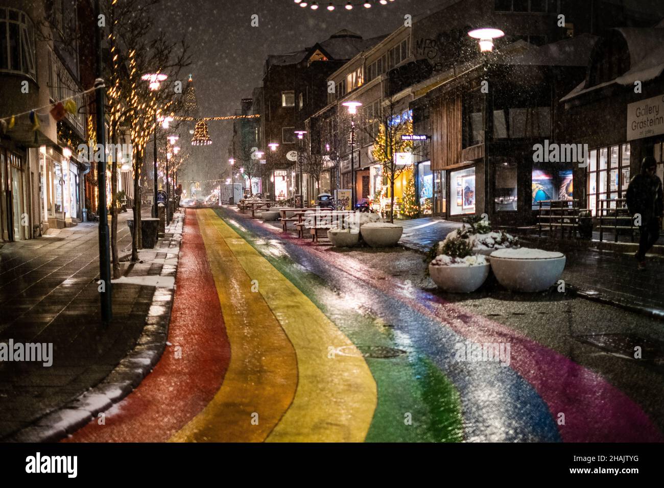 Reykjavik Iceland street scene rainbow night time lighting snow falling ...
