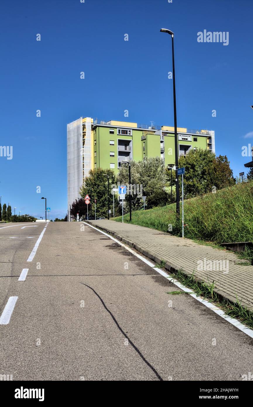 Road in a residential area with a building on its side Stock Photo - Alamy