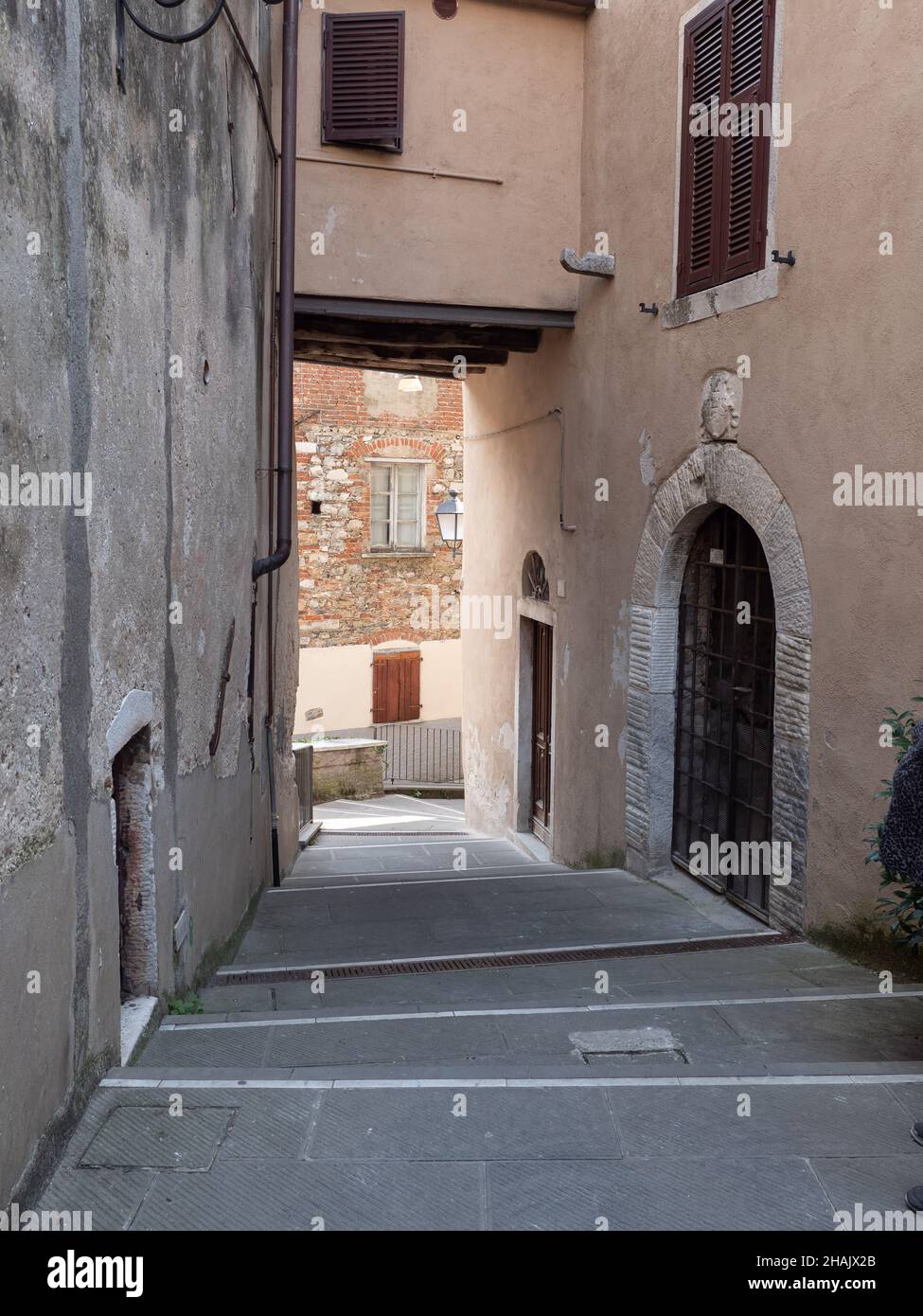 Narrow Street with Ancient Walls and Houses in the Village of Colonnata ...