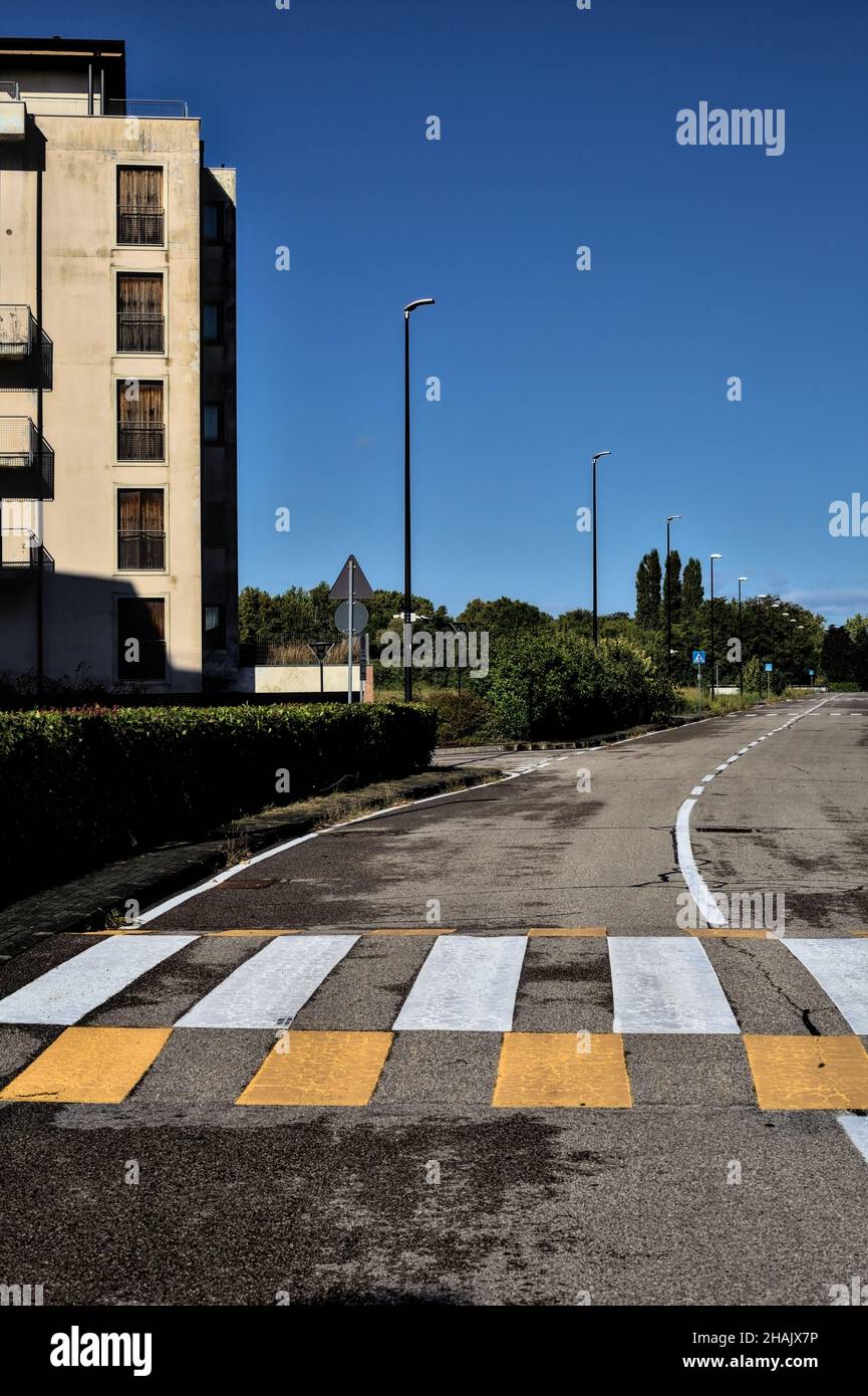 Road in a residential area with a building on its side Stock Photo - Alamy