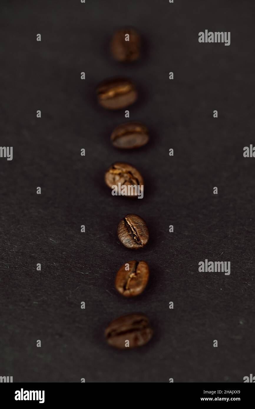 Close Up Coffee Beans in a Row on Dark Background Vertical with Bokeh ...