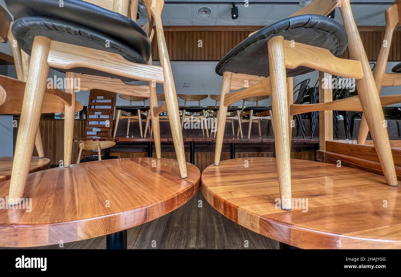 Chairs on tables in closed cafeteria Stock Photo - Alamy